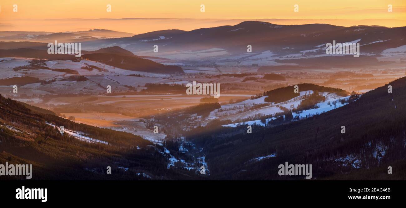 Winter panorama of Morava Valley from Snieznik summit in sunset light ...