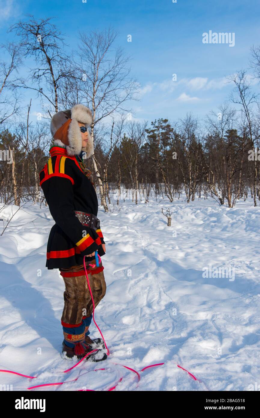 Photo of a Sami teenage boy with sunglasses in the snow at the Sami ...