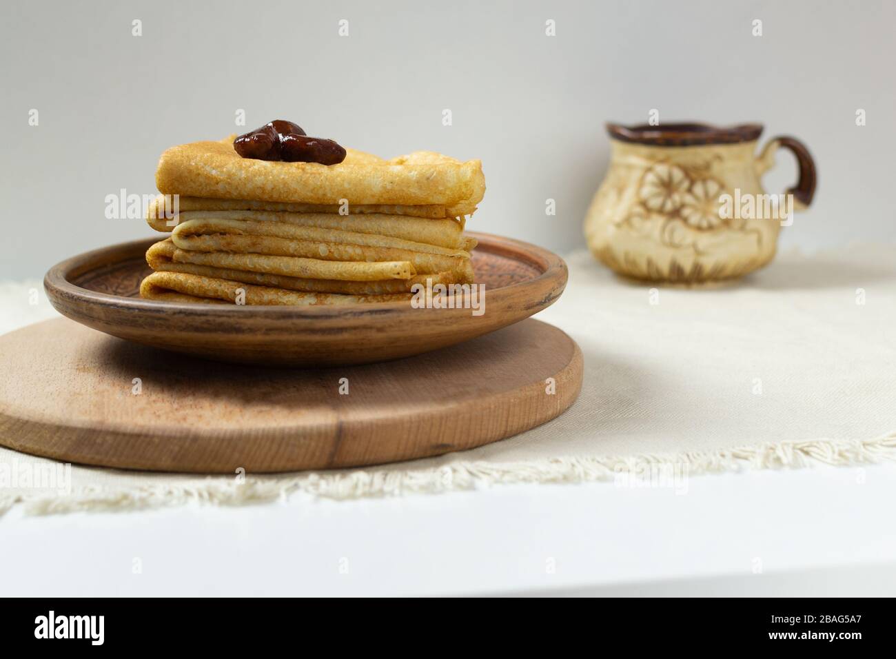 Pancakes (Russian Blini) with strawberry jam and tea in a rustic style ...
