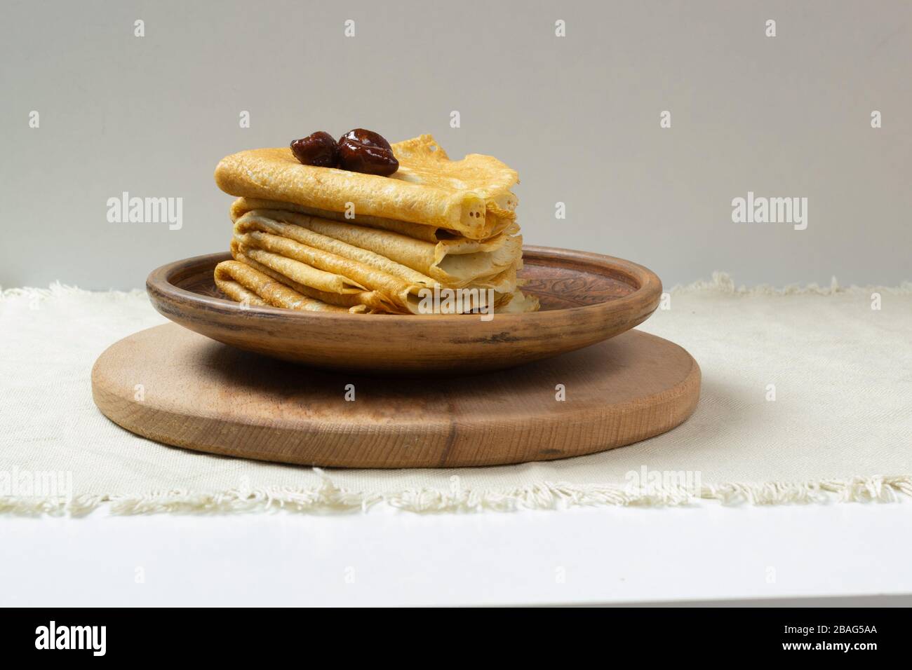 Pancakes (Russian Blini) with strawberry jam and tea in a rustic style ...