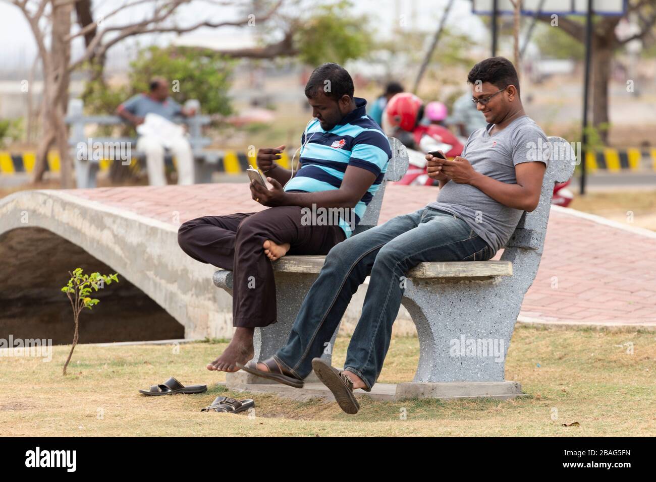 Two local men on their phones at the waterfront in Jaffna, Sri Lanka ...