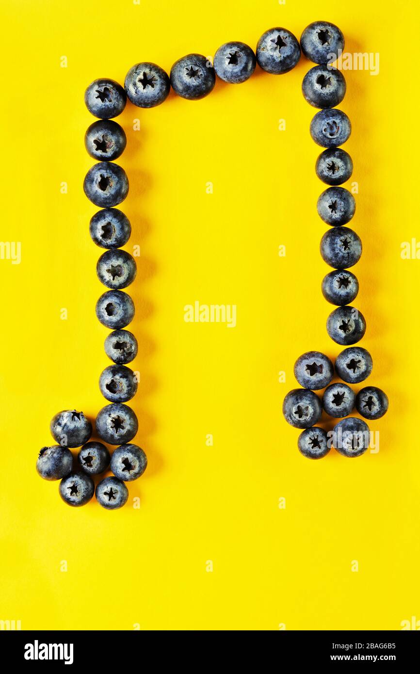 Musical note with black blueberry on yellow background , creativity at ...