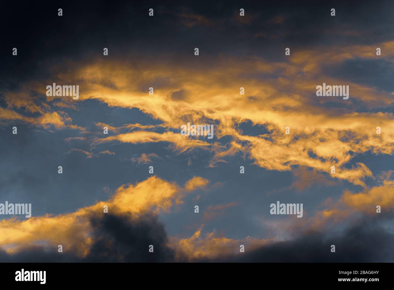 Stunning fluffy thunderstorm clouds illuminated by disappearing rays at ...
