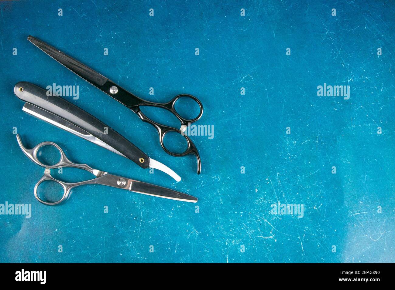 Scissors on blue background. Barber shop concept Stock Photo - Alamy