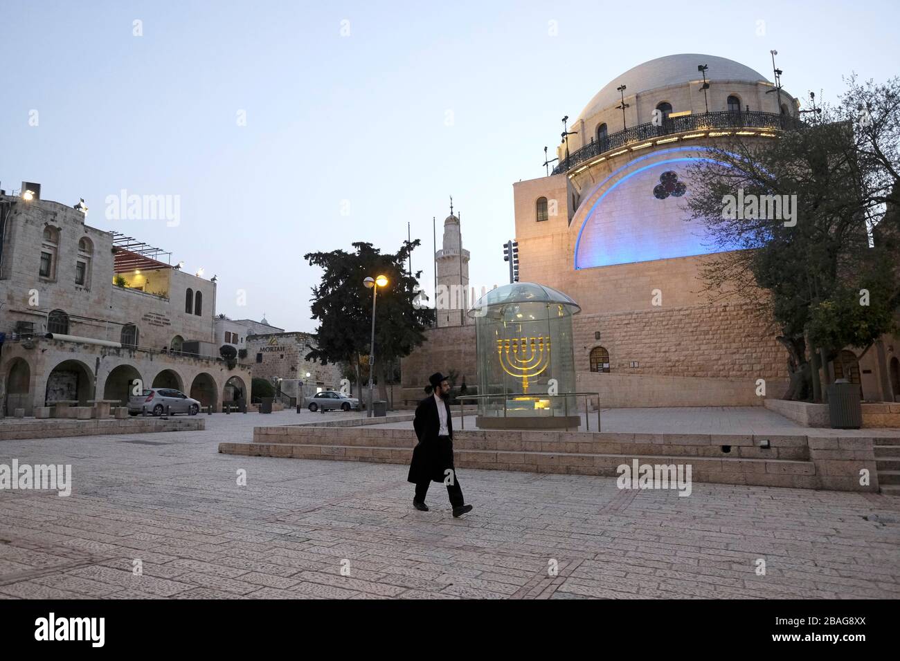 A lone Orthodox Jew walks past the Hurva square at the Jewish Quarter ...