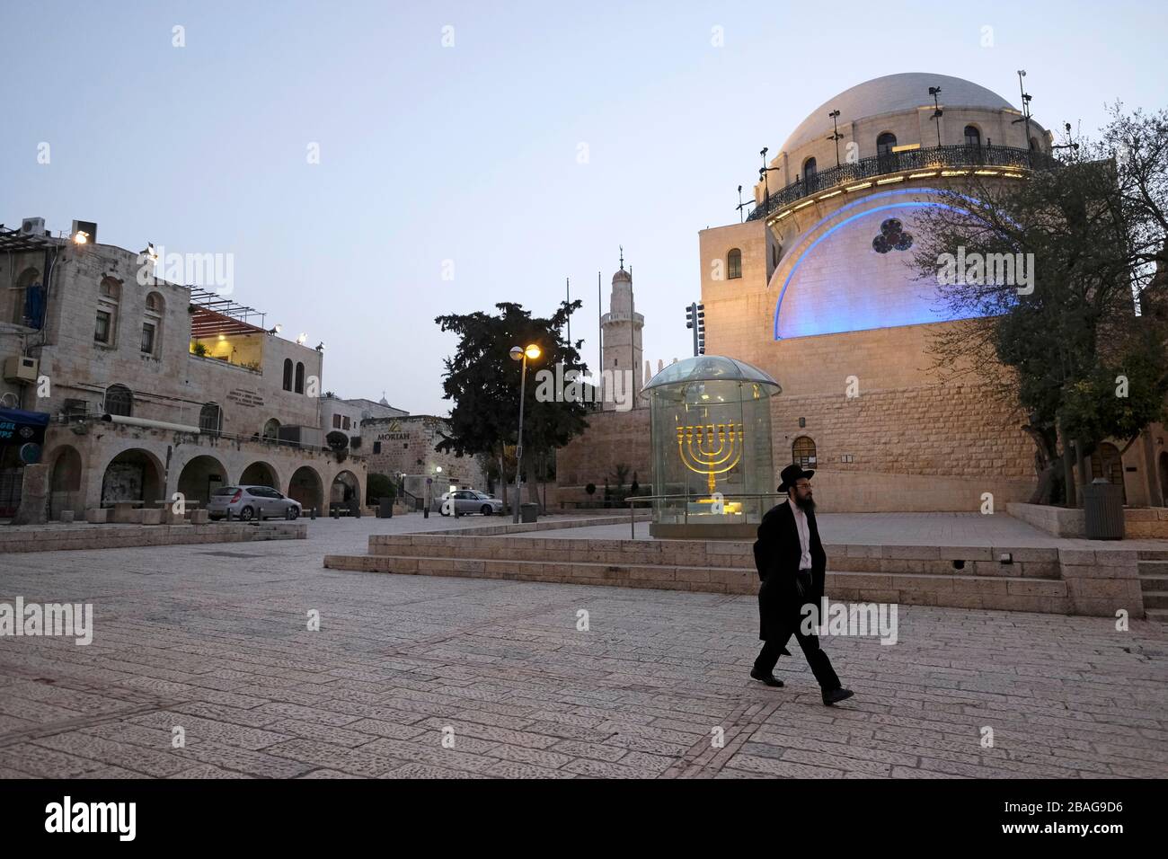A lone Orthodox Jew walks past the Hurva square at the Jewish Quarter ...