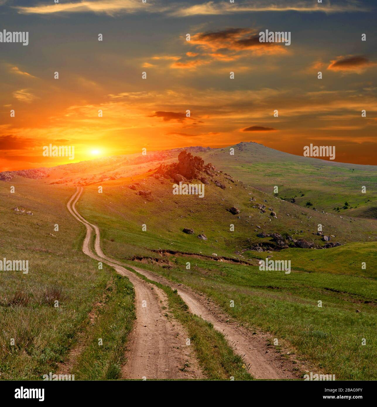 Mountain road on sunset background Stock Photo - Alamy