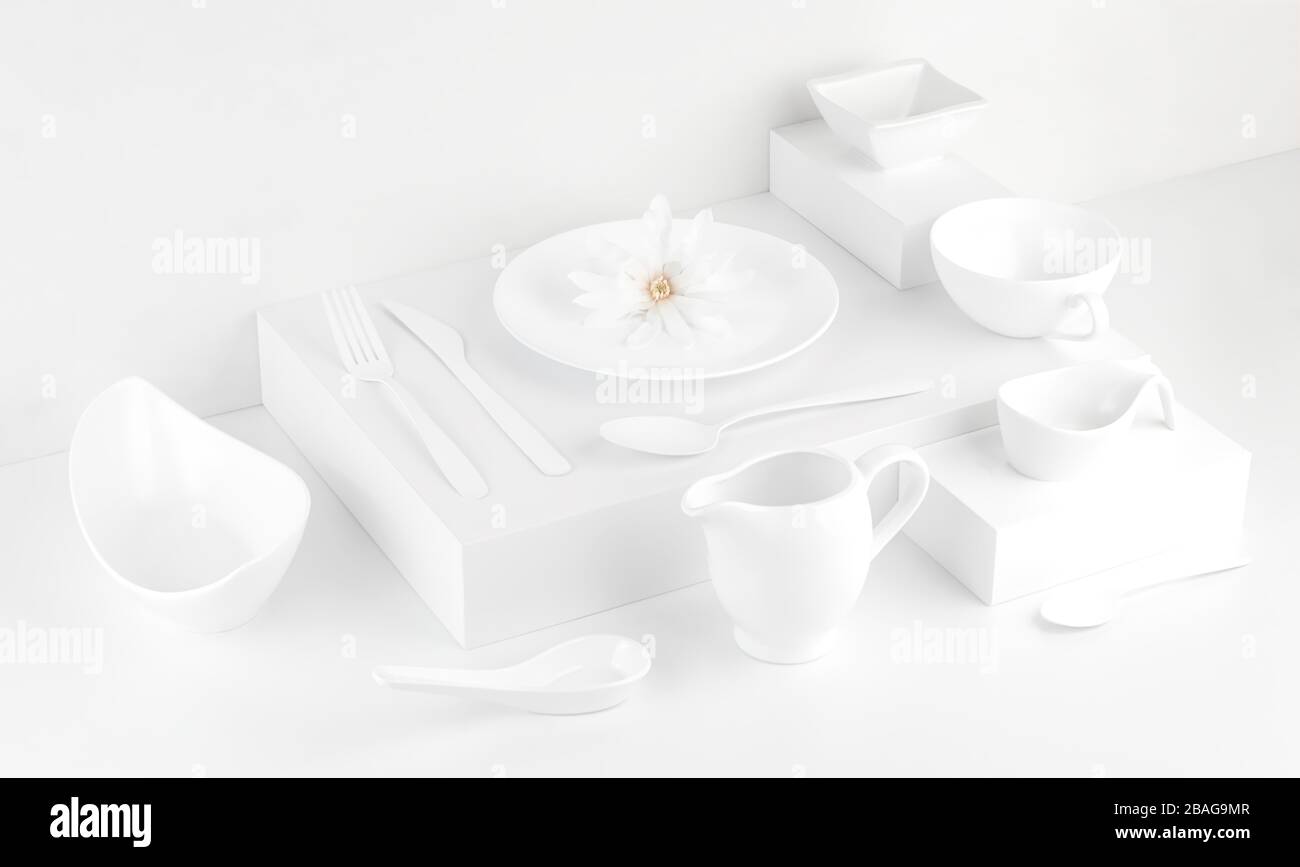 Cutlery and white tableware on a white background without shadows ...