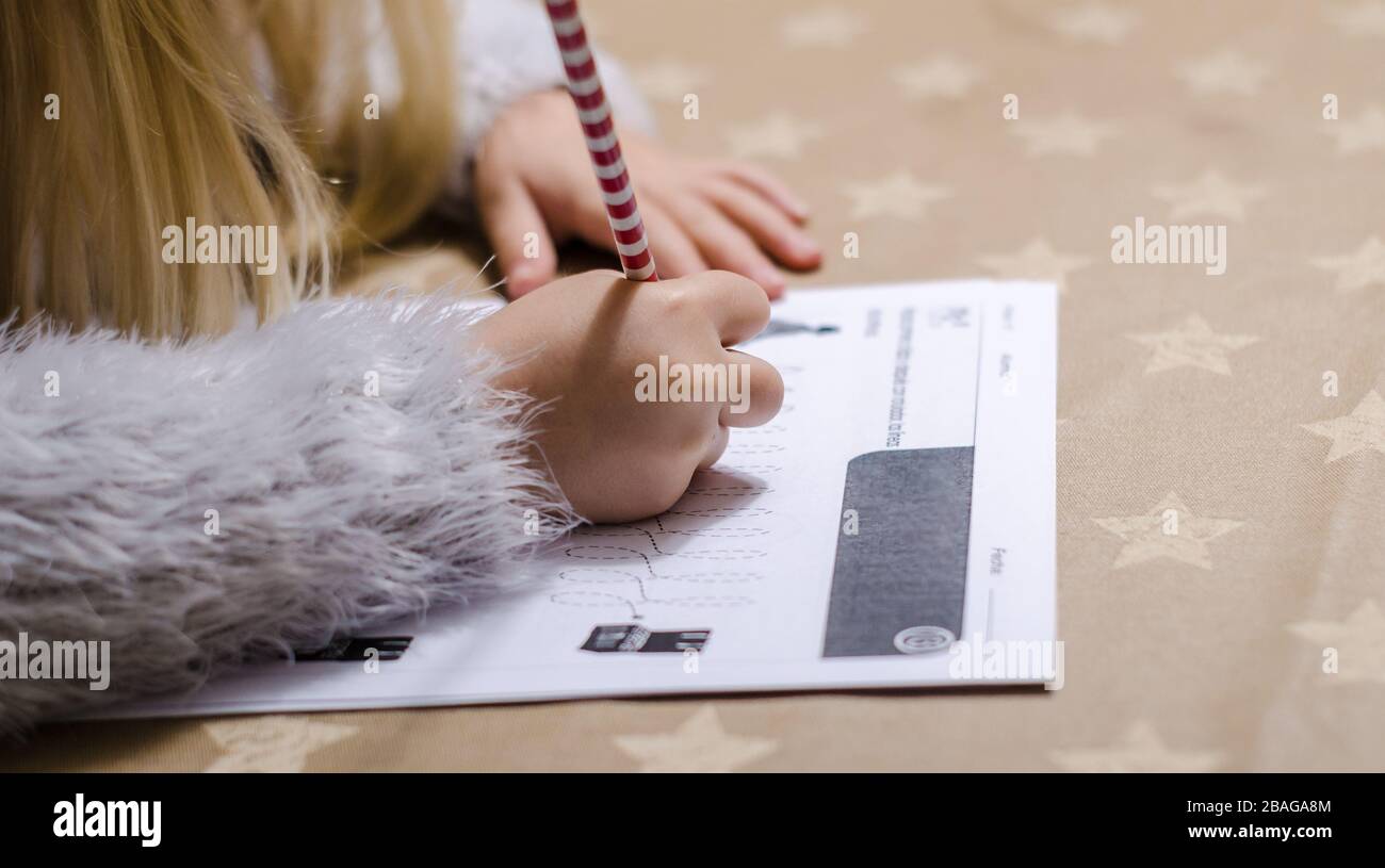 LITTLE GIRL HAND DOING HOMEWORK Stock Photo - Alamy