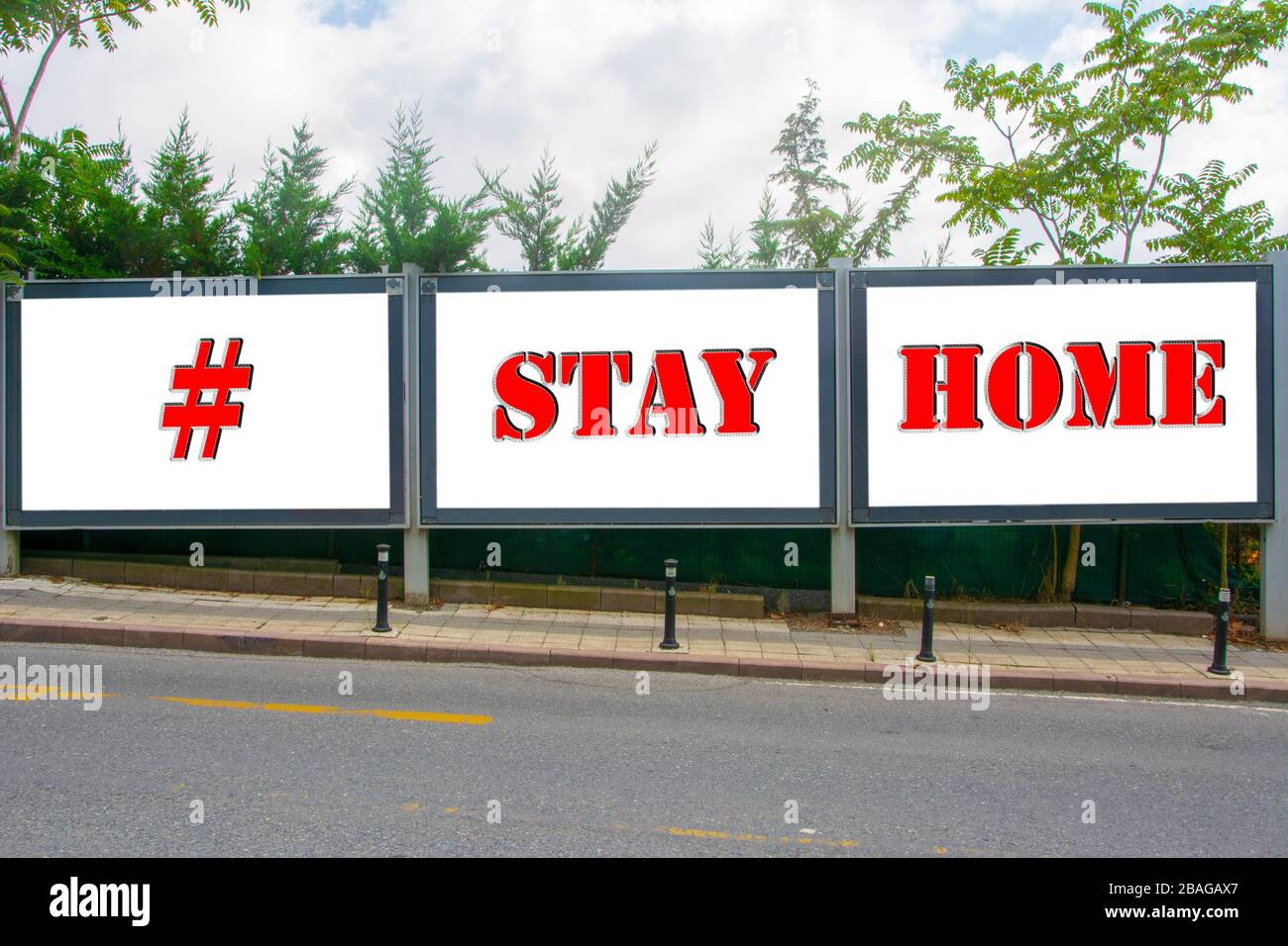 Billboard with the poster of stay home on the roadside in the street ...