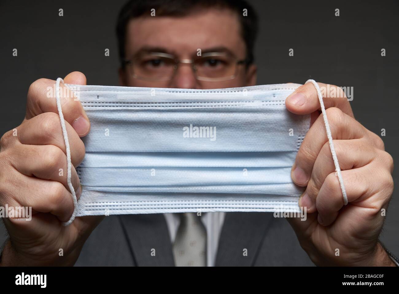a man demonstrates a protective face mask for antivirus individual ...