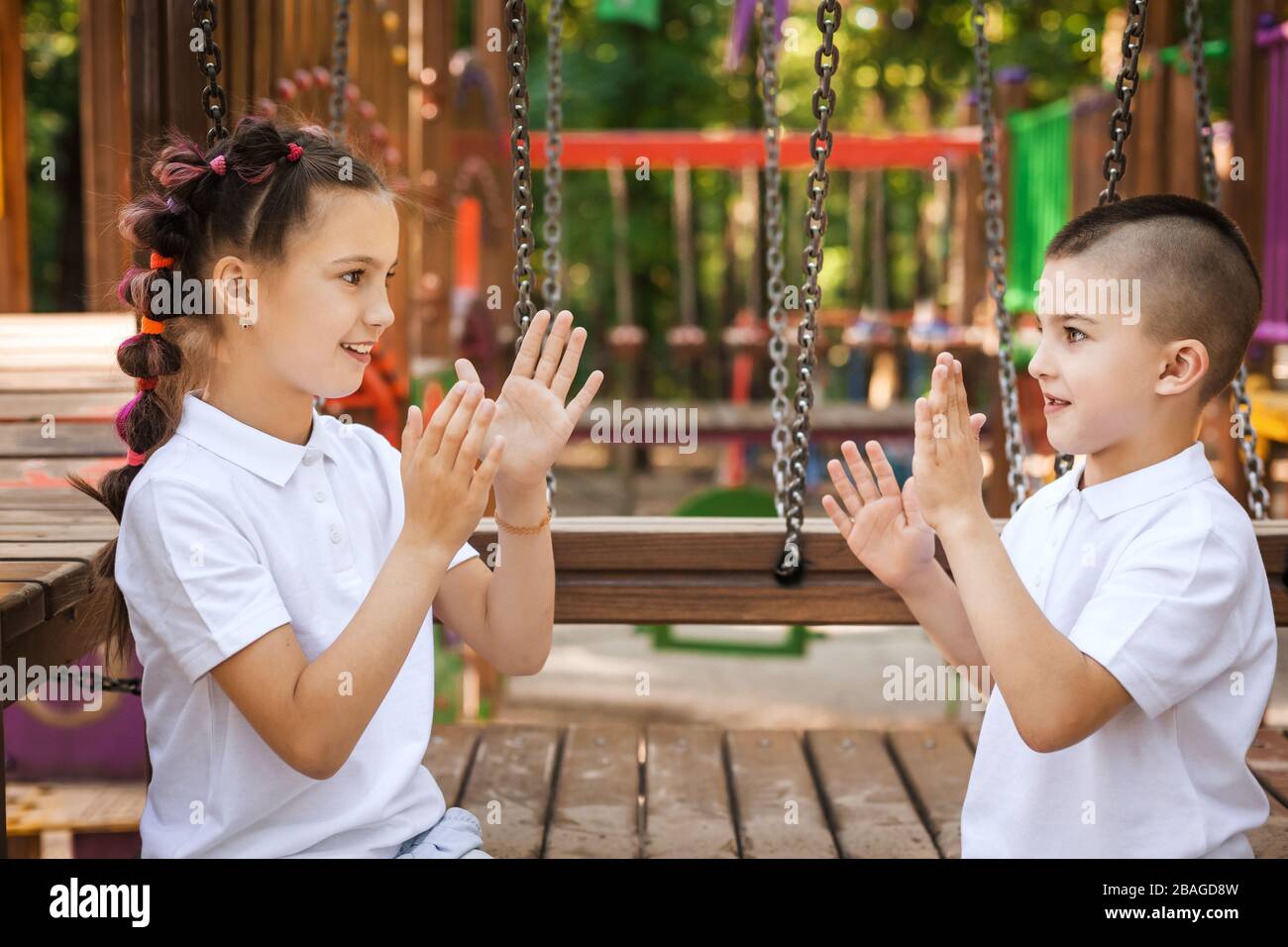 happy boy and girl clapping hands Stock Photo - Alamy