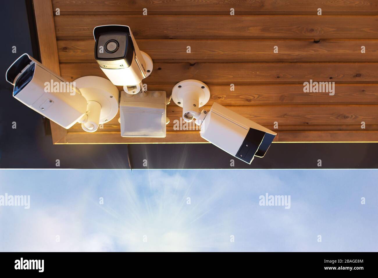 Security cameras under the roof with buildings and sky background Stock ...