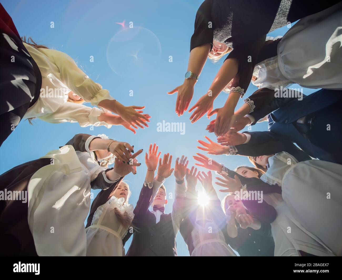 High school students join hands in a sign of strong friendship and ...