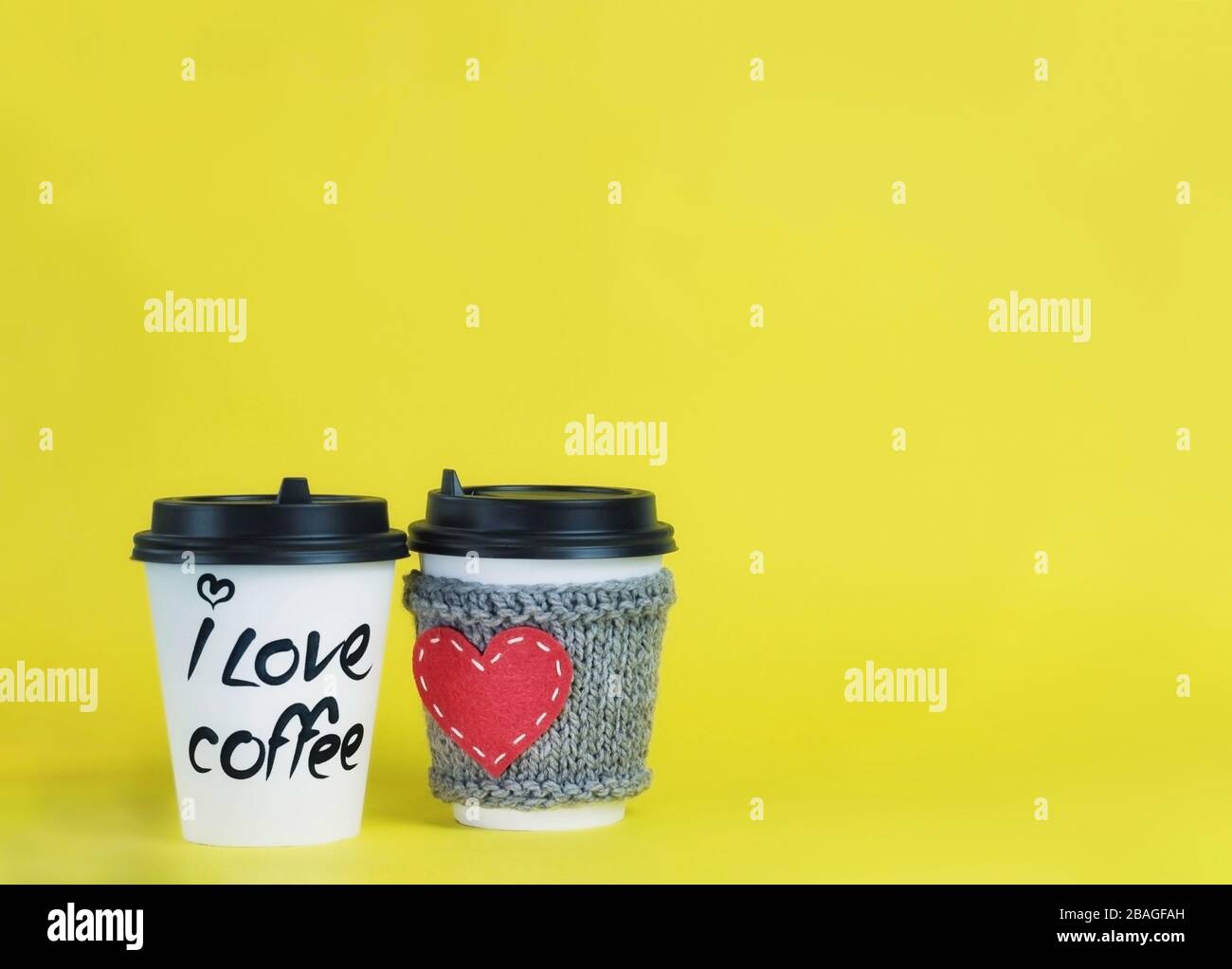 Two paper cup on a yellow background Stock Photo - Alamy