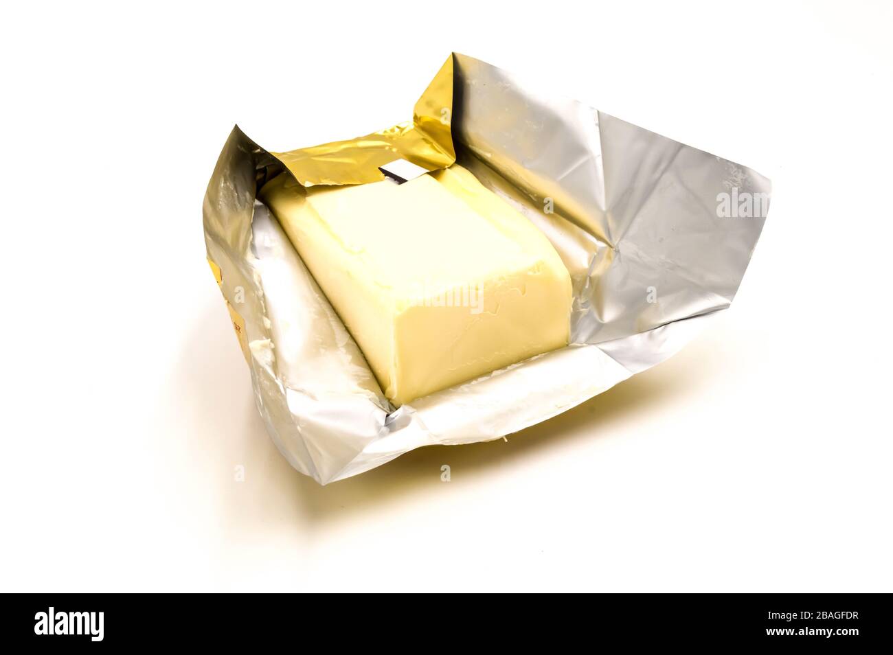 Block of rectangular fresh butter with packaging on white background ...