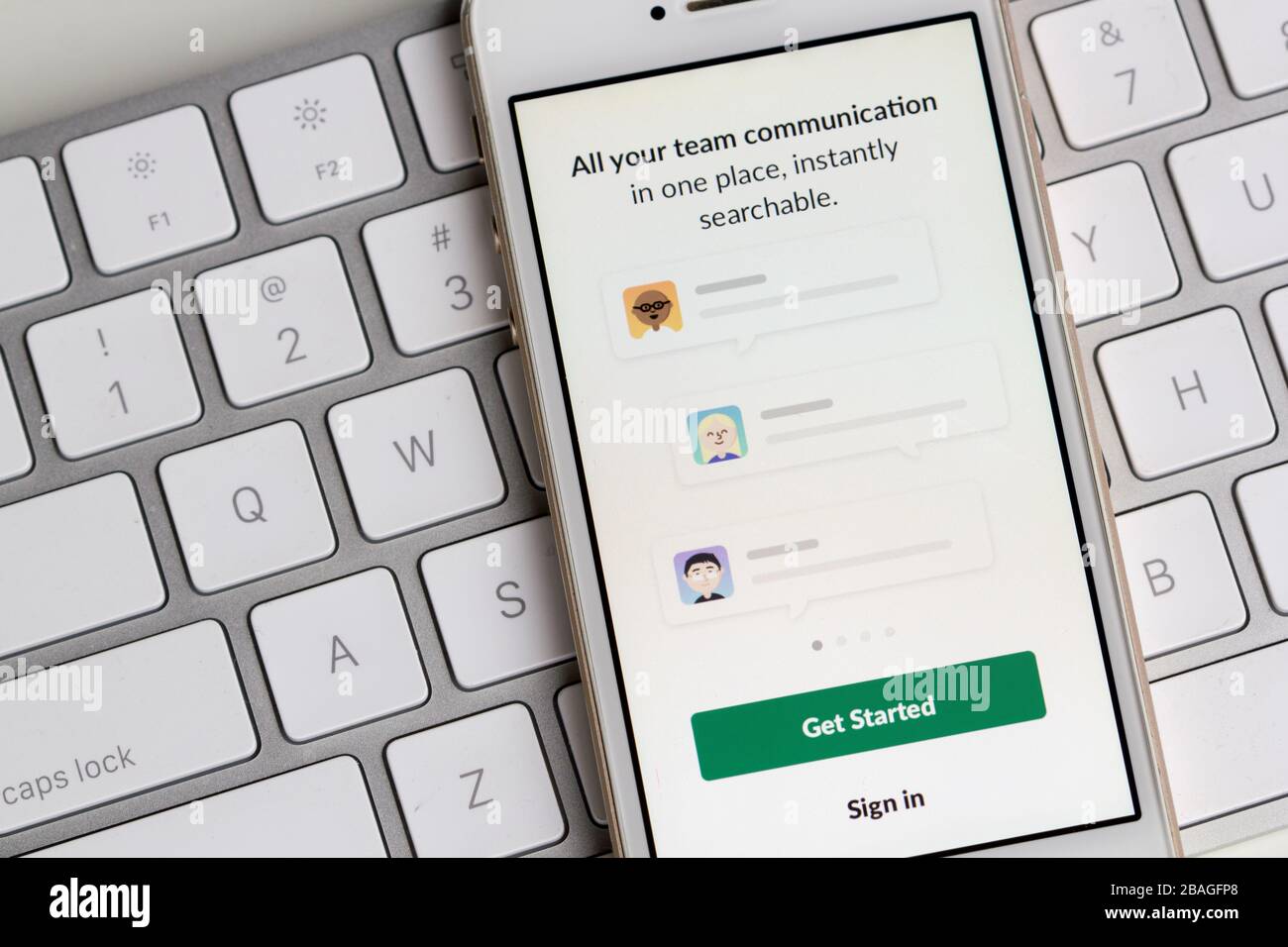 Slack mobile app login screen is seen on a smartphone. Slack is a B2B ...