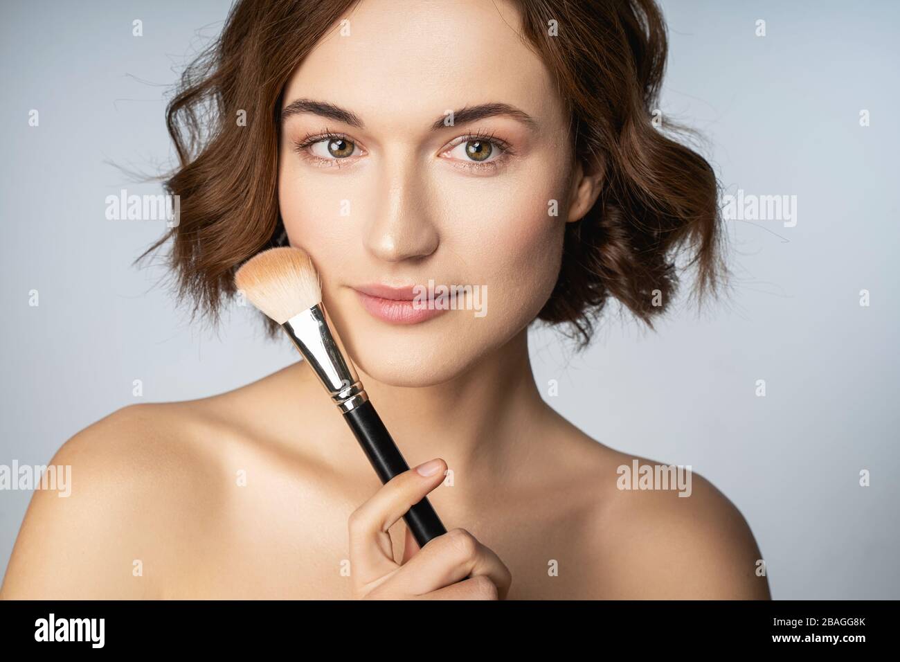 Cheerful young female person standing isolated on grey Stock Photo - Alamy