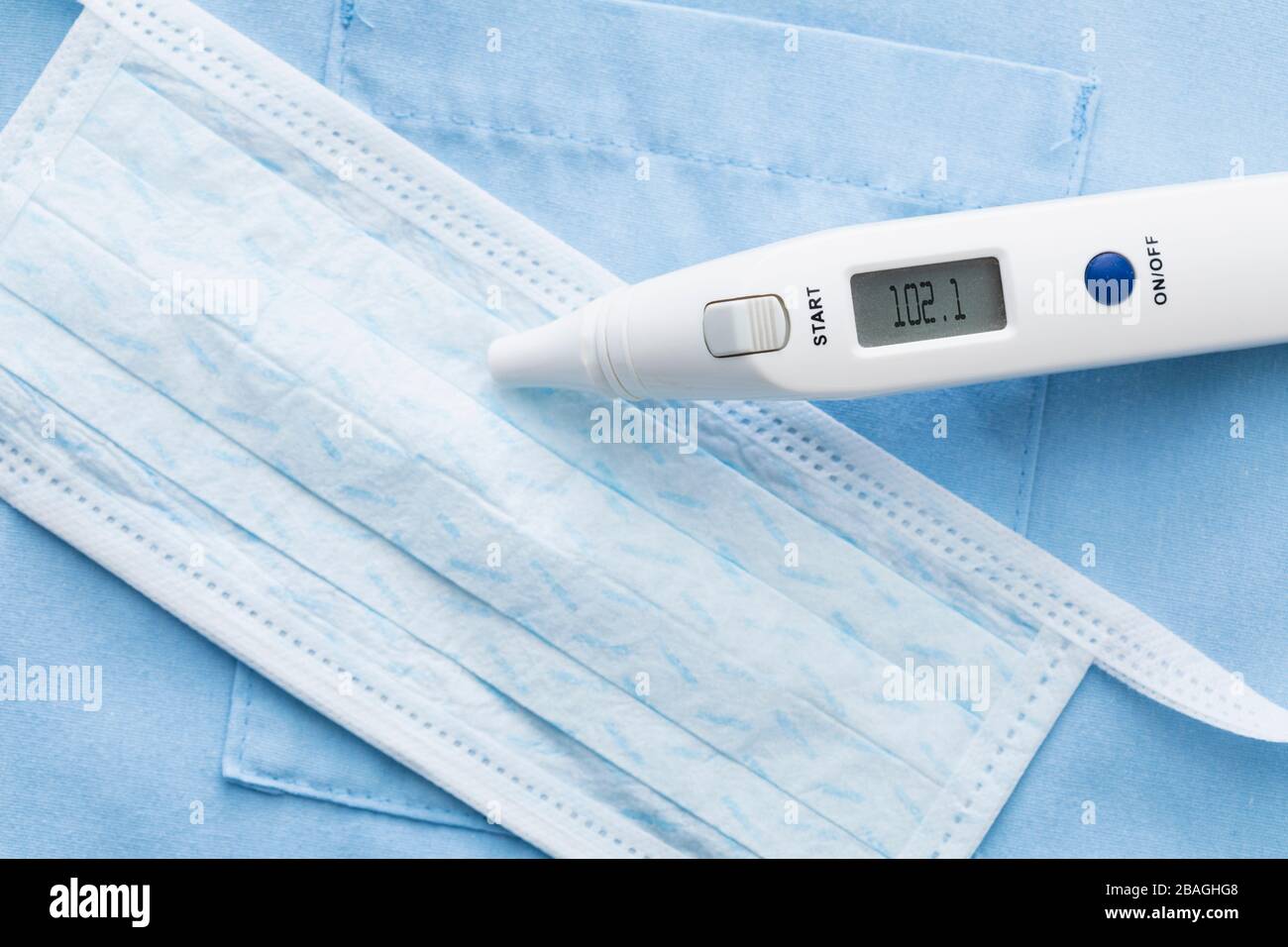 Thermometer displaying fever and surgical mask Stock Photo - Alamy
