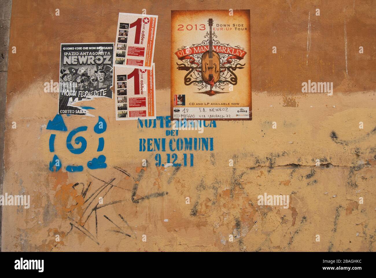 Street posters and graffitis on the wall in Pisa, Tuscany, Italy Stock ...
