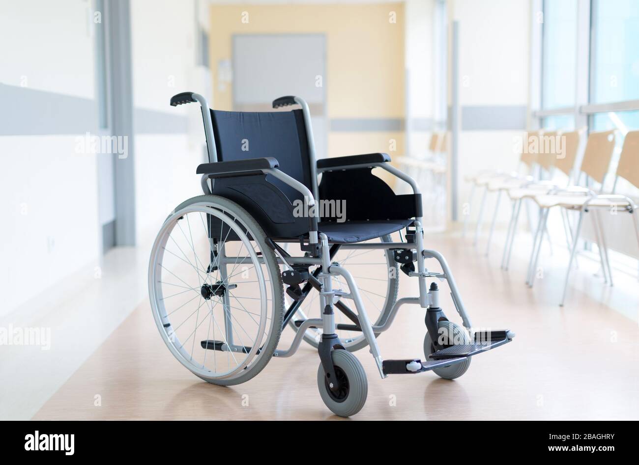 Empty wheelchair in hospital corridor Stock Photo - Alamy