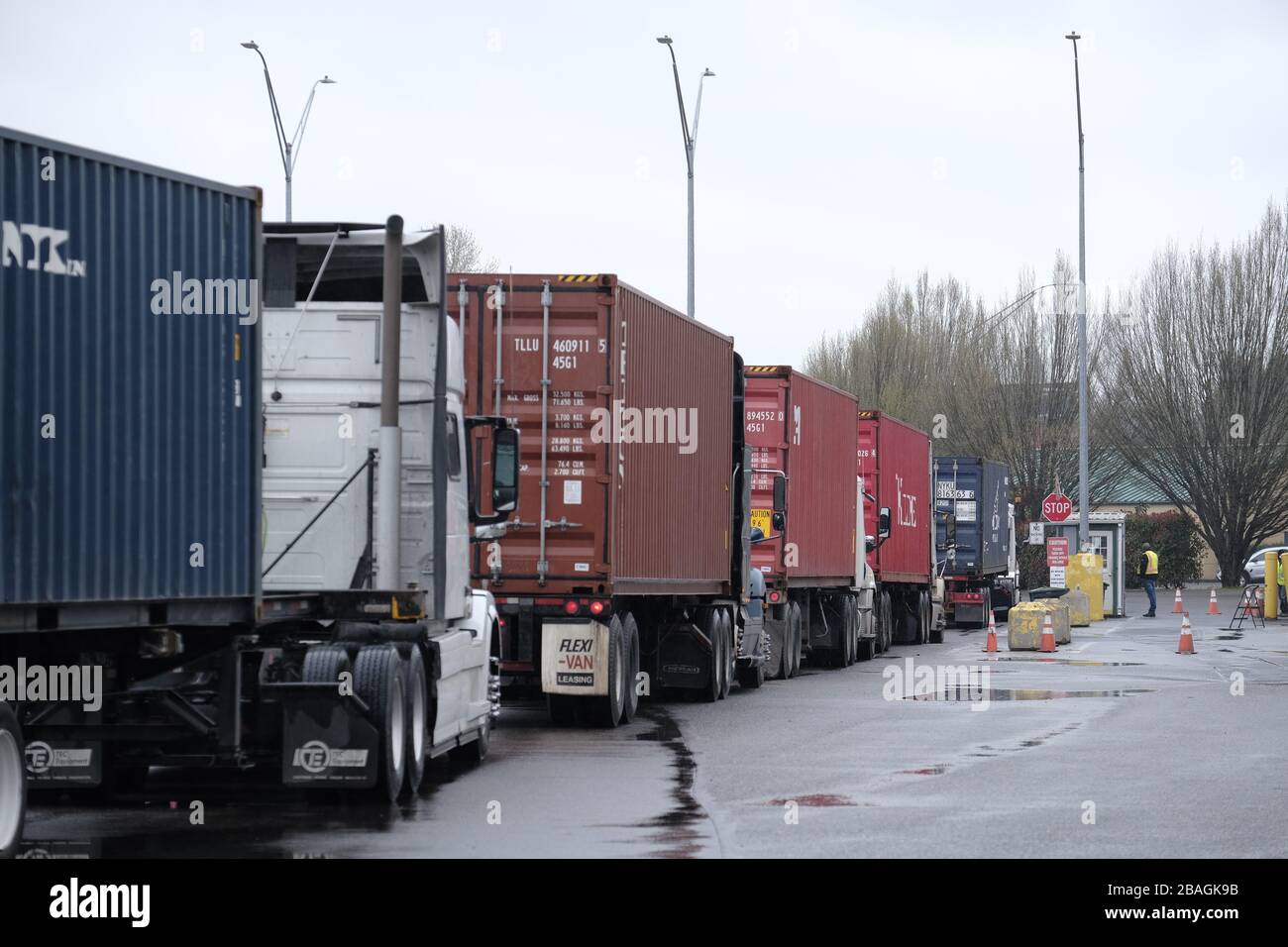 Portland, USA. 27th Mar, 2020. Truck drivers wait to check their cargo ...