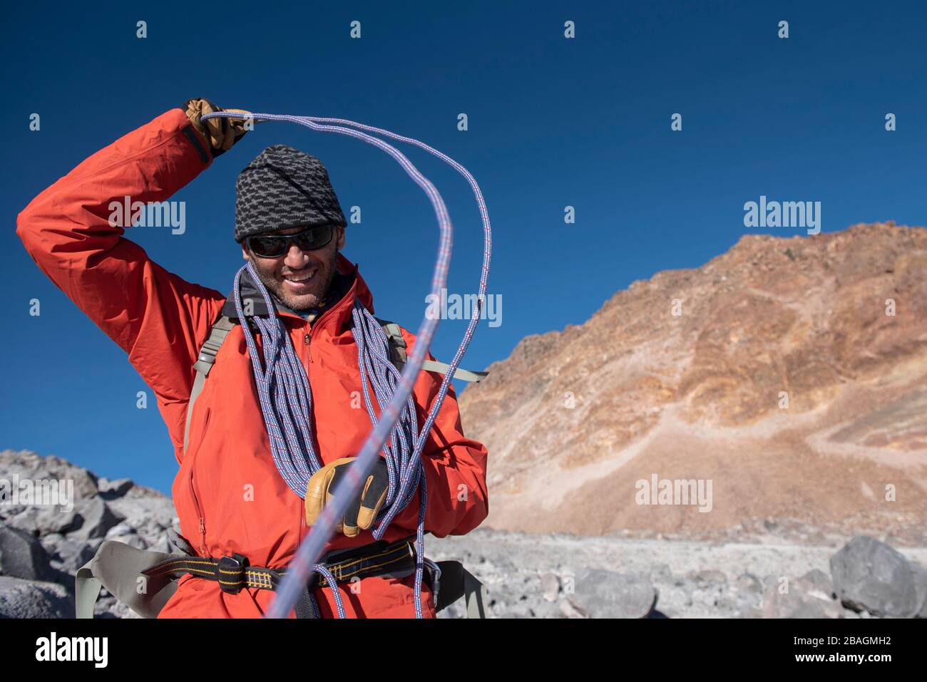 One man wrapping a rope around his head while climbing Pico de Orizaba ...