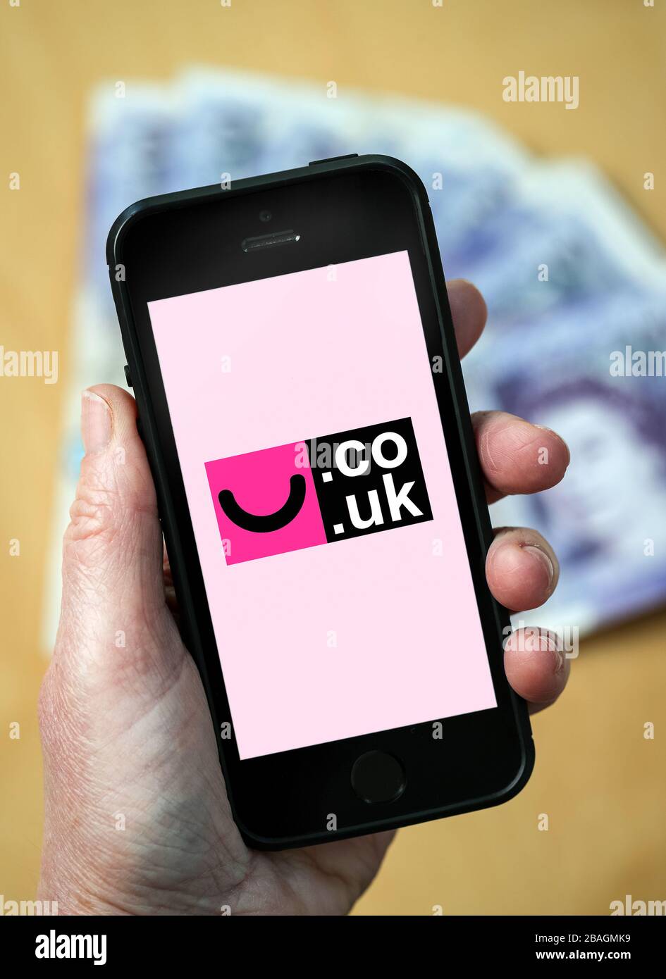 A woman looking at the Smile Bank logo on a mobile phone. (editorial ...