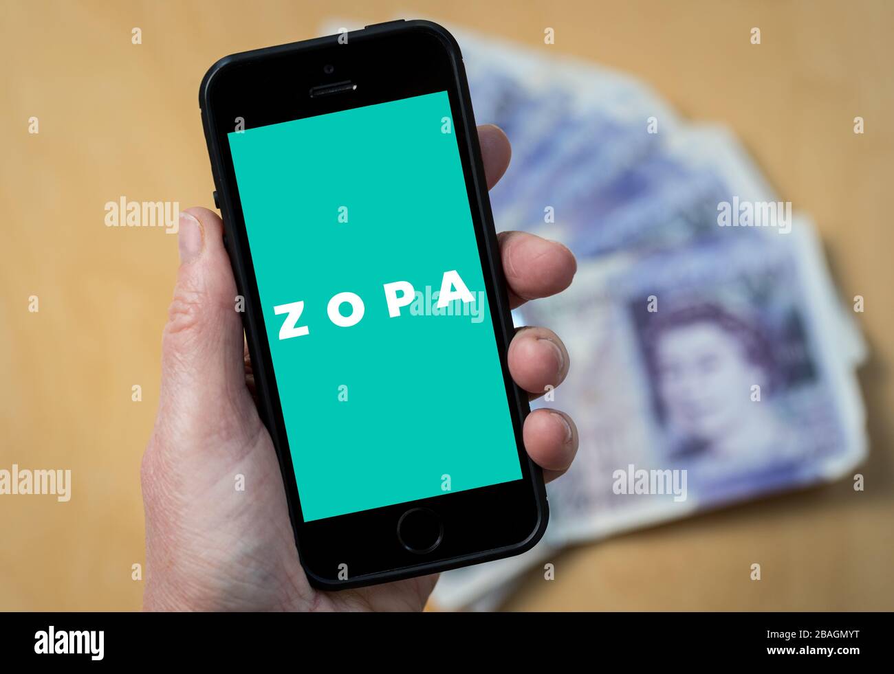 A woman looking at the Zopa Bank logo on a mobile phone. (editorial Use ...