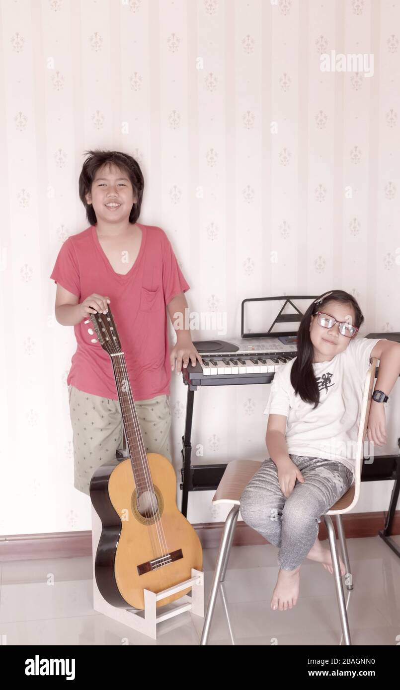 Brother and sister with their favorite music instruments Stock Photo ...