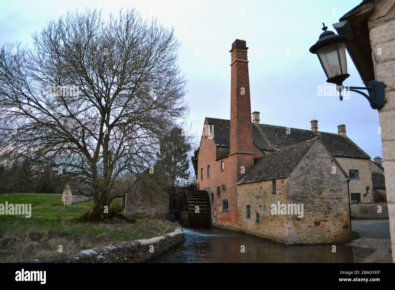 Traditional English water mill: water wheel and river in the ...
