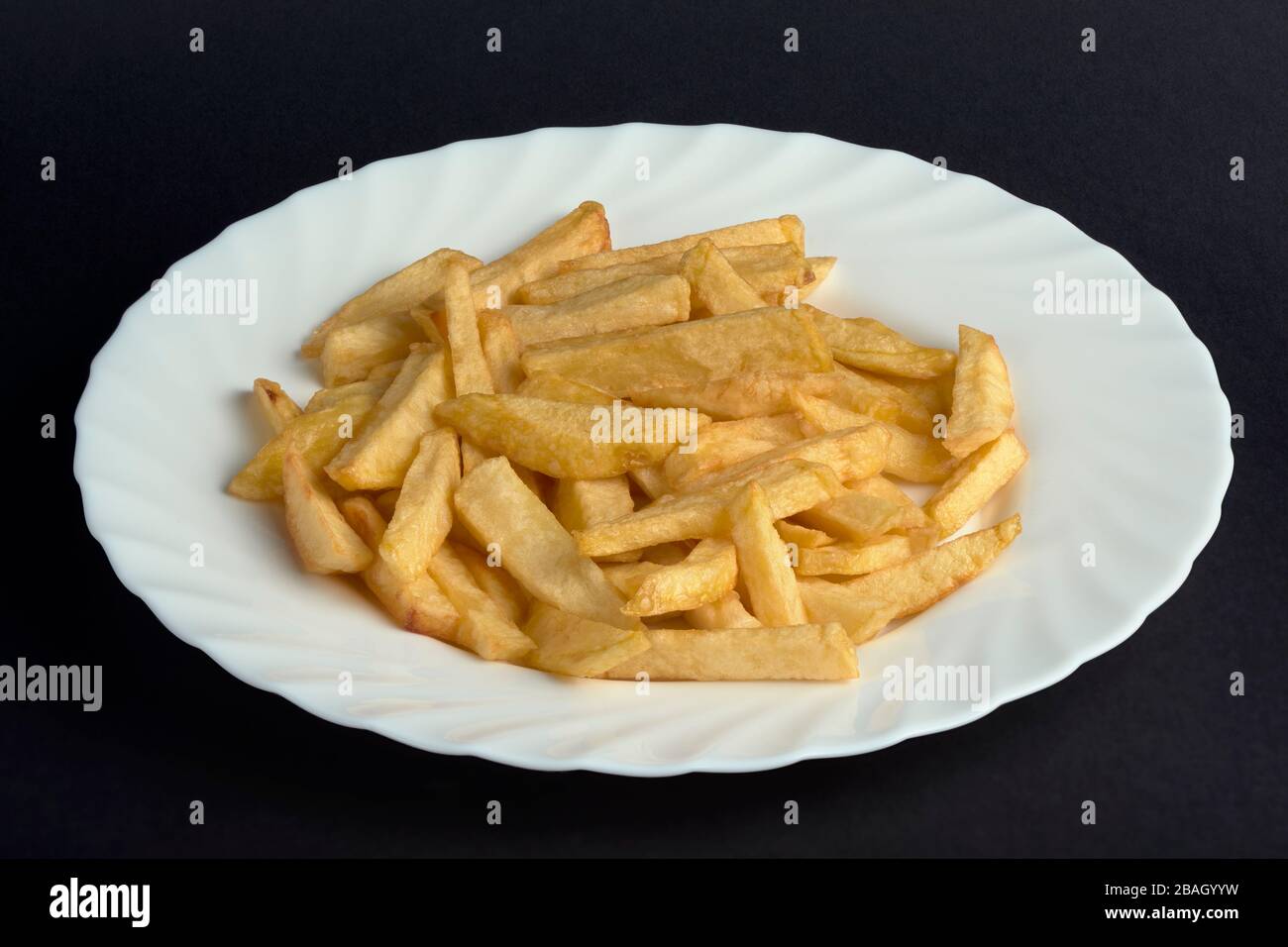 White plate on black background with large and small fries Stock Photo ...
