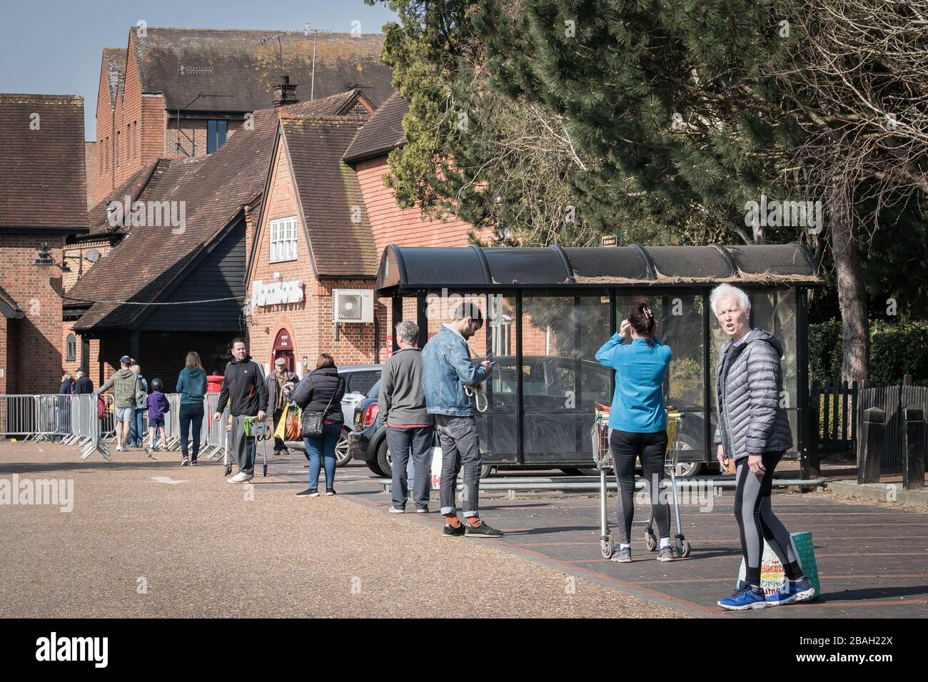 Reigate, Surrey, UK - March 28, 2020 - shoppers queueing outside ...