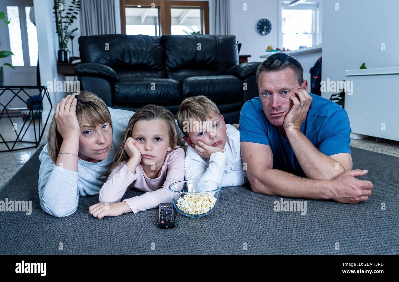 Coronavirus lockdow. Bored family watching tv helpless in isolation at ...