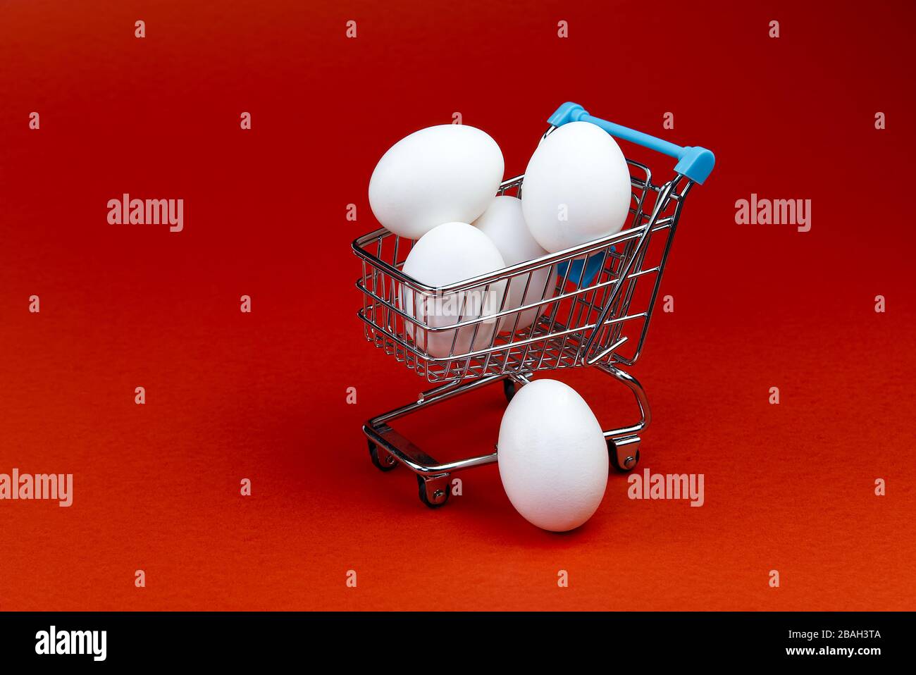 chicken white eggs in a shopping cart. isolated on red Stock Photo - Alamy
