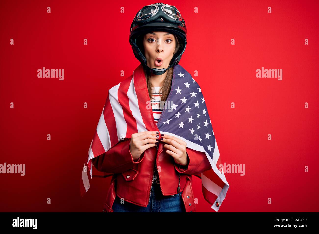 Young beautiful patriotic motorcyclist woman wearing motorcycle helmet ...