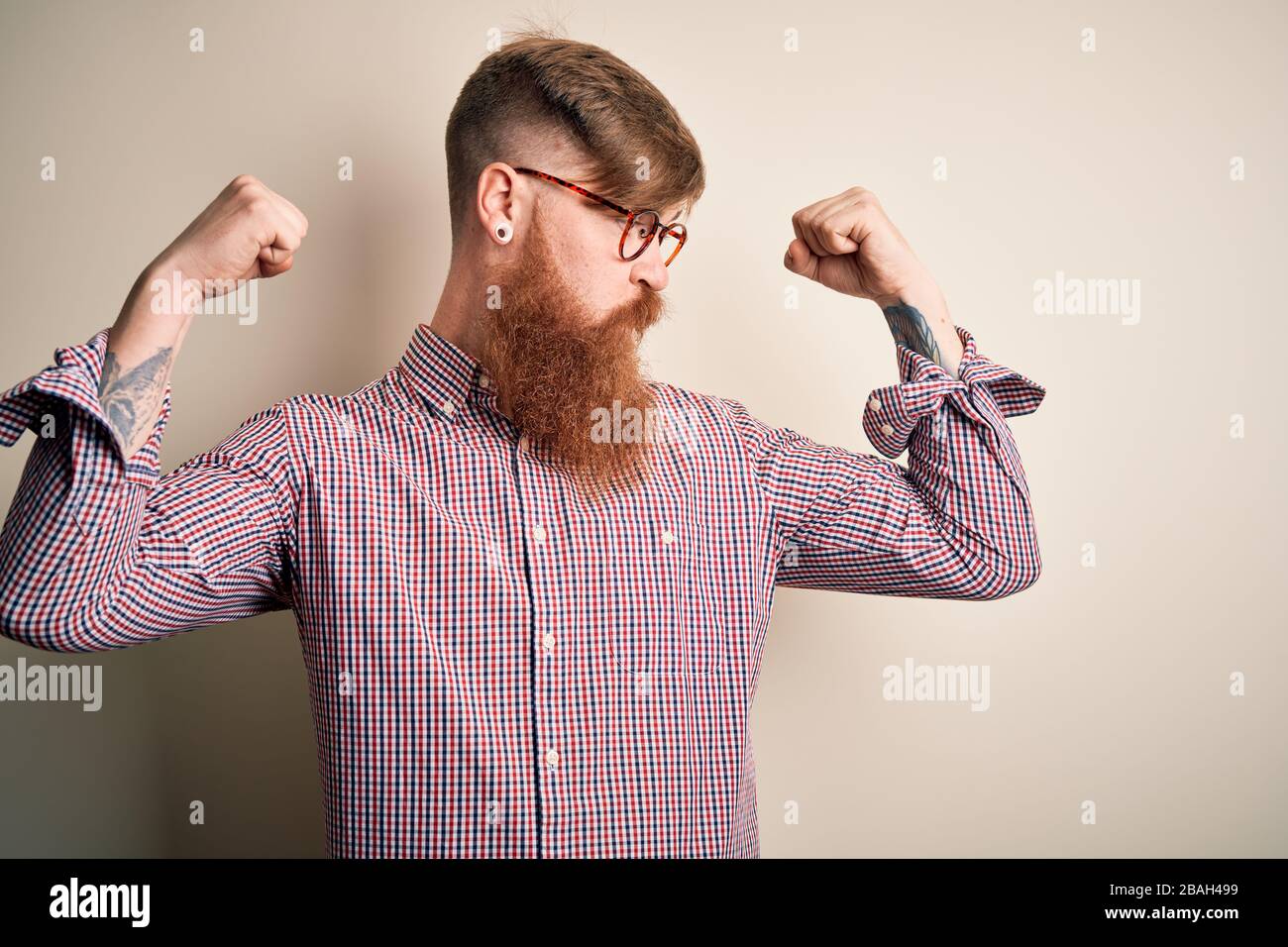 Handsome Irish redhead business man with beard wearing glasses over ...