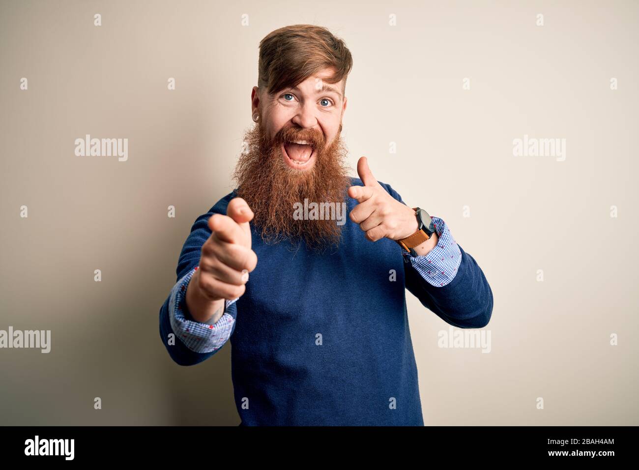 Handsome Irish redhead business man with beard standing over isolated ...