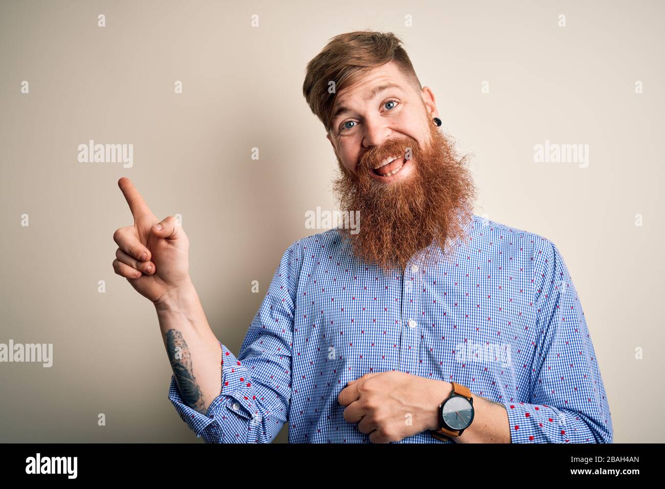 Handsome Irish redhead business man with beard standing over isolated ...