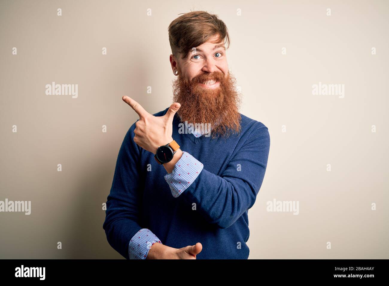 Handsome Irish redhead business man with beard standing over isolated ...