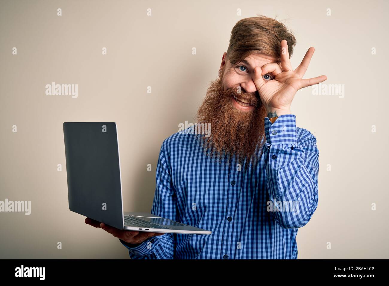 Redhead Irish business man with beard using computer laptop over ...