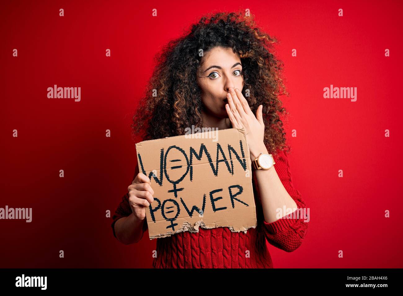 Activist with curly hair and piercing protesting holding poster with ...