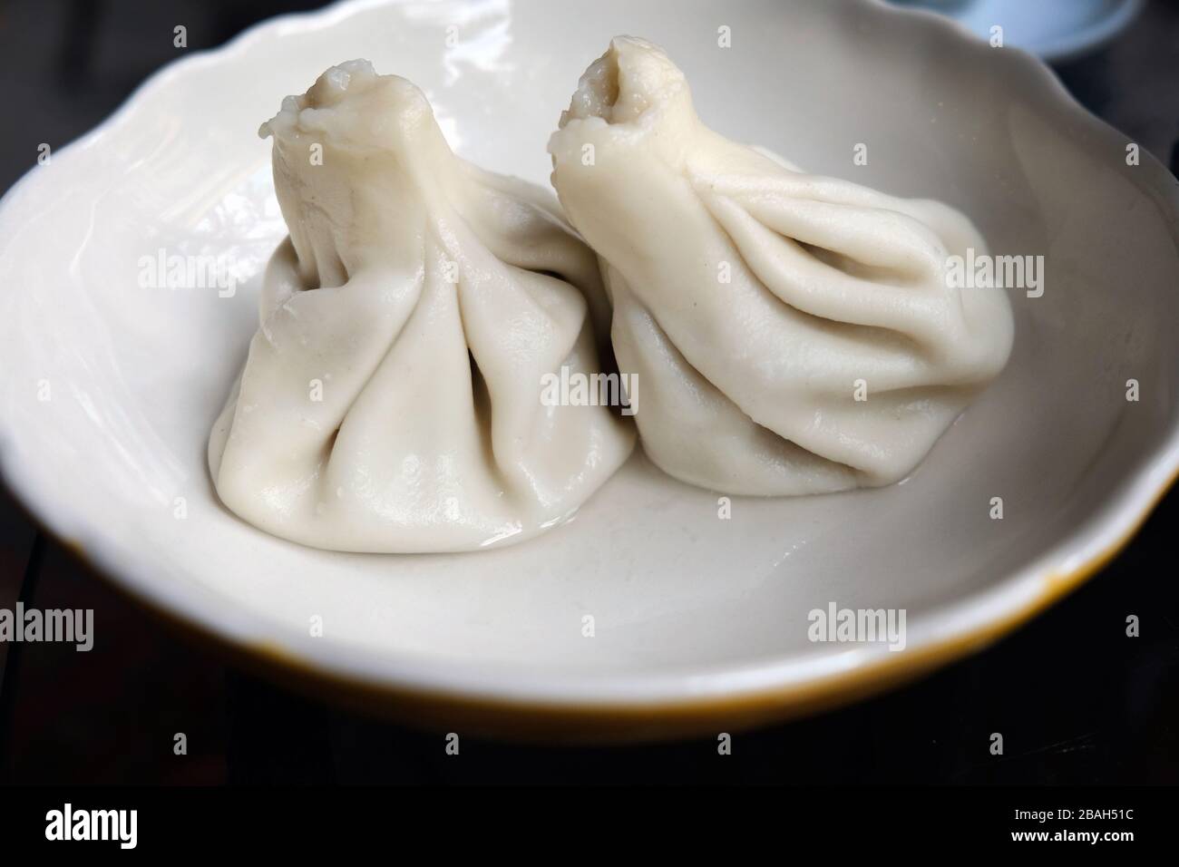Two Georgian khinkali on a plate. Traditional food in Georgia ...