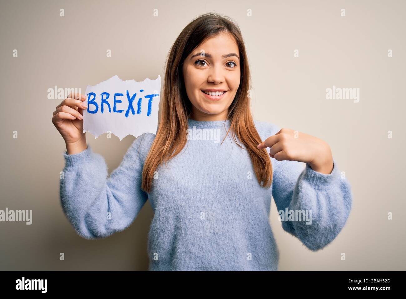 Young blonde woman holding brexit banner from political referendum over ...