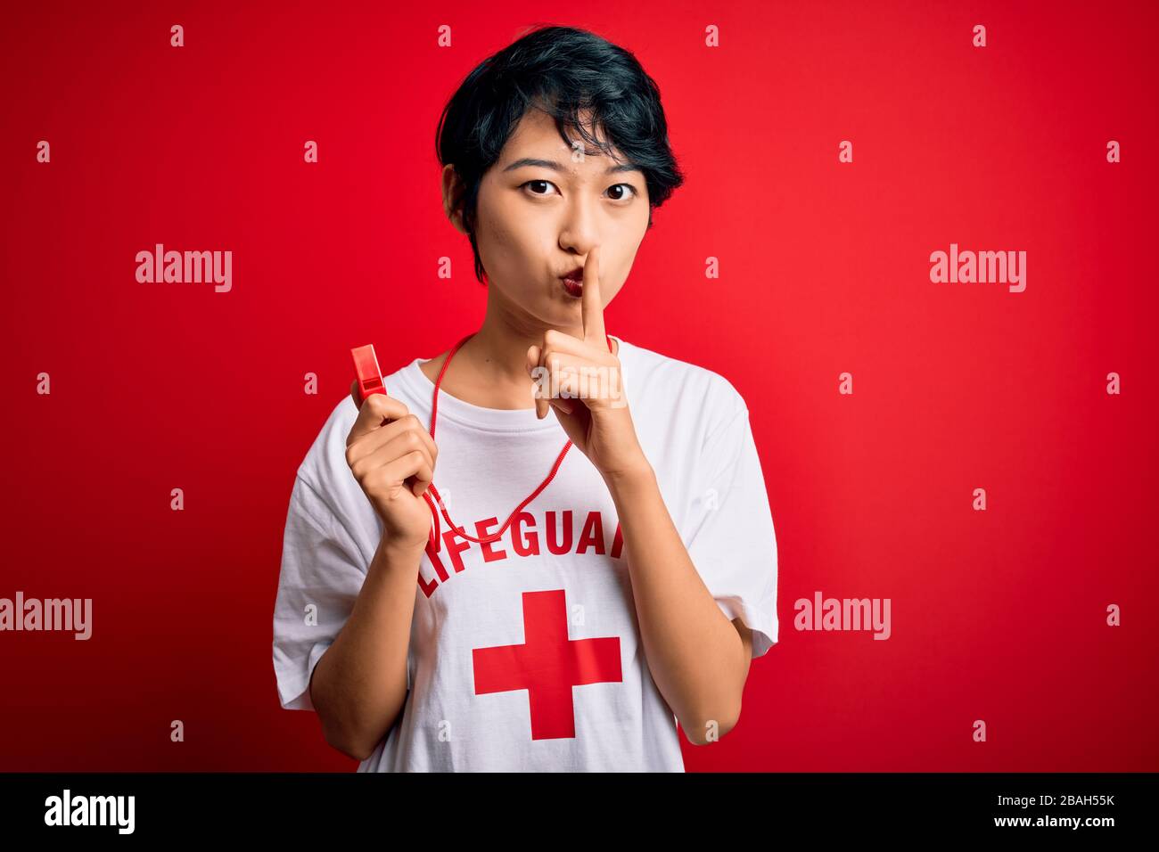 Young beautiful asian lifeguard girl wearing t-shirt with red cross ...