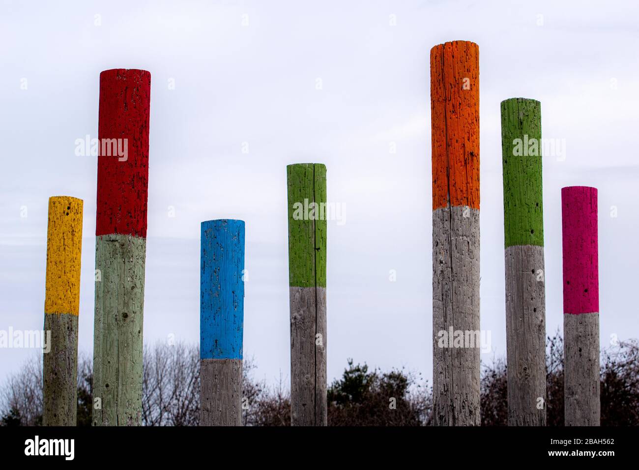 wooden posts with colourful tips Stock Photo - Alamy