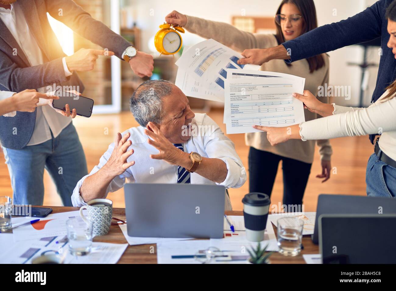 Group of business workers working together. Partners stressing one of ...