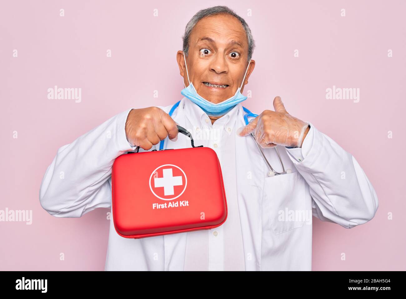 Senior handsome hoary doctor man wearing stethoscope and medical mask ...