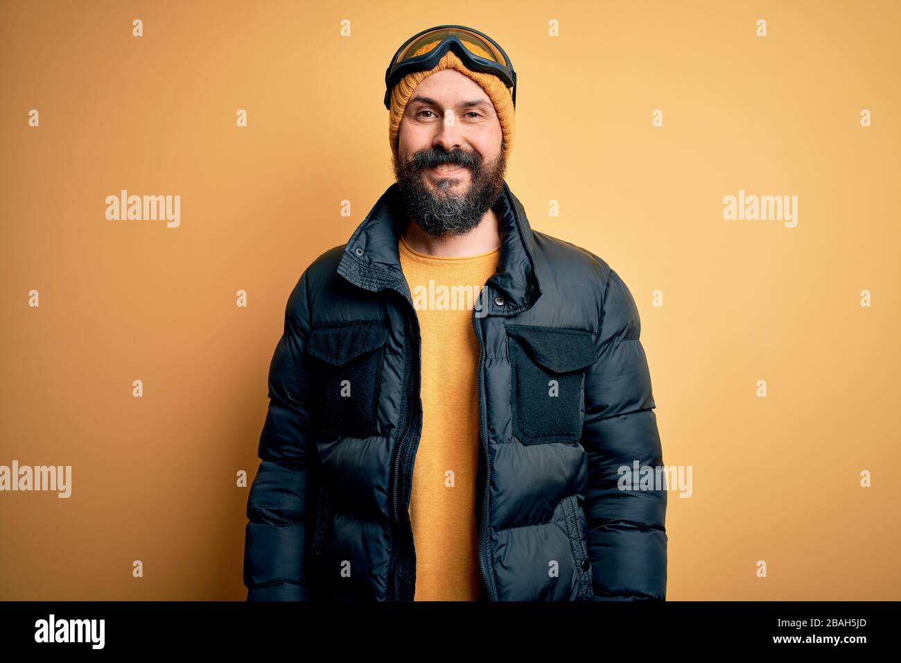 Handsome skier bald man with beard skiing wearing snow sportswear and ...