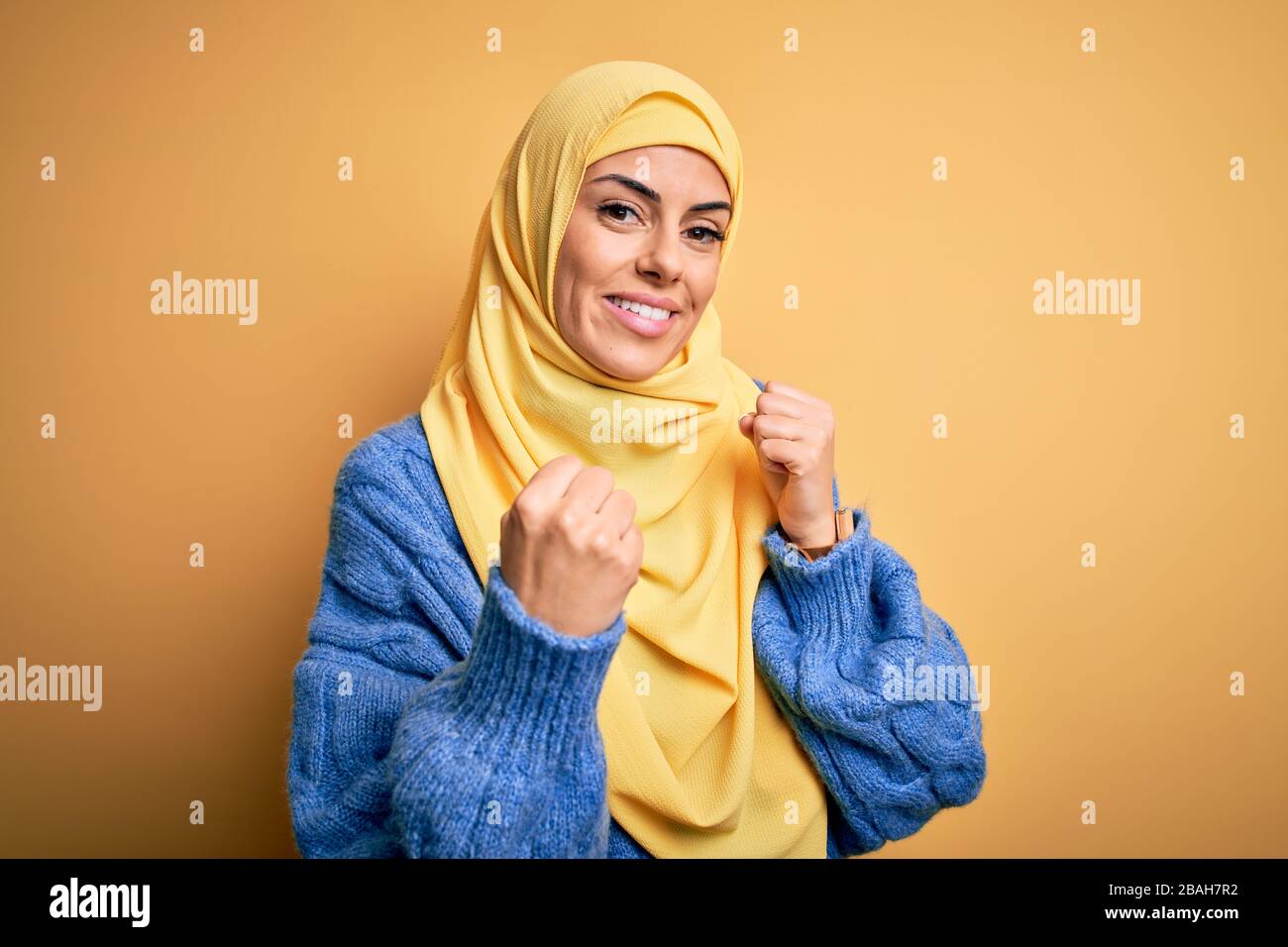 Young beautiful brunette muslim woman wearing arab hijab over isolated ...